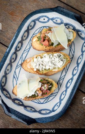 tapas with Bruschetta and creamed herb cheese on toast in rustic ...