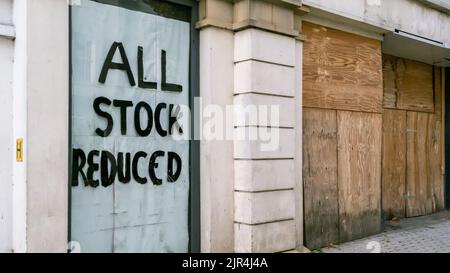All Stock Reduced Sign on Empty Retail Storefront Stock Photo - Alamy