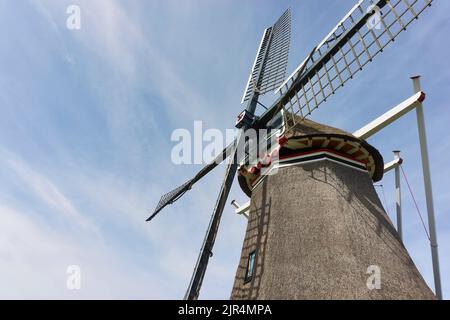 Closeup of the four wings of a traditional thatched dutch windmil in ...