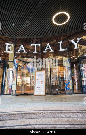 Main entrance and brightly lit interior to Eataly Italian restaurants ...