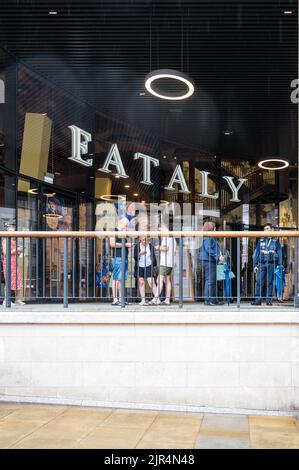 People grouped at the entrance to Eataly Italian restaurant, bar and ...