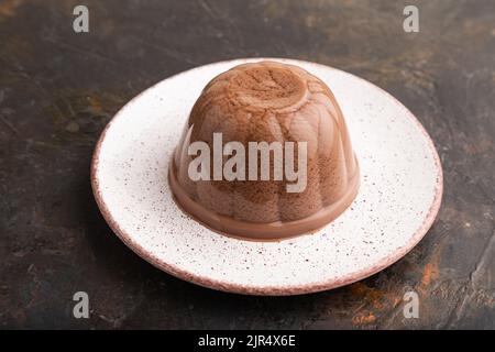 Chocolate jelly on black concrete background. side view, copy space ...