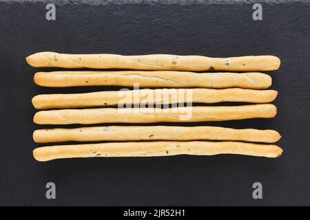 Fresh Italian Grissini Breadsticks served on black background. Dry ...