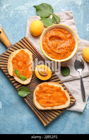 Composition with delicious sandwiches and apricot jam on color ...
