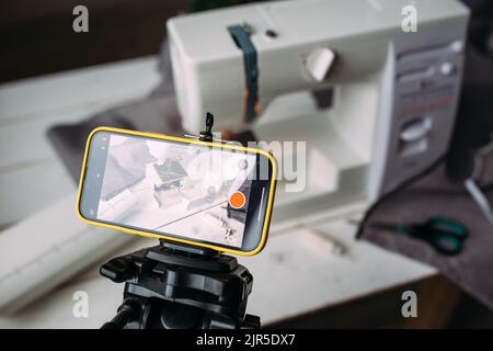 Shooting video of the sewing process, workshop on clothing design on ...