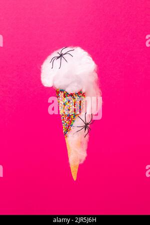 Ice cream cone with sprinkles, spider web and spiders on green ...