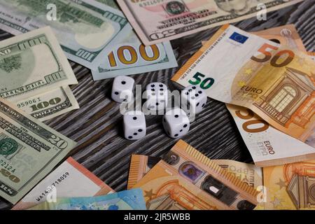 Dice among dollar and euro banknotes. Multicurrency savings. Risk while ...