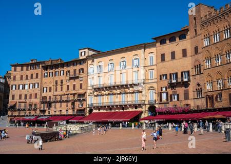 Medieval buildings surrounding Piazza del Campo with the Campanile bell ...