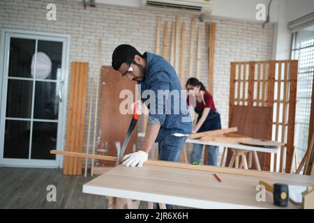 Carpenter grinding joinery product with carvings, finishing woodwork at ...