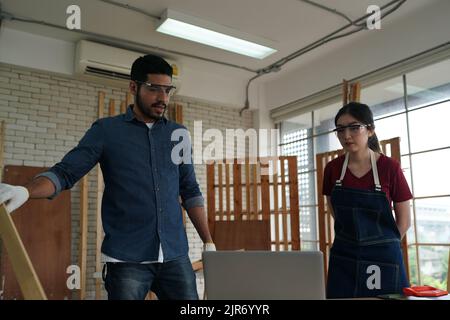 Carpenter grinding joinery product with carvings, finishing woodwork at ...