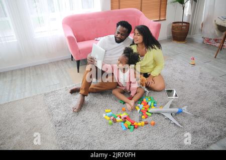 Shot of happy interracial family of mother father and their daughter ...