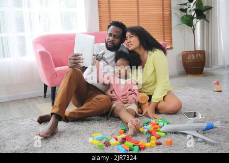Shot of happy interracial family of mother father and their daughter ...