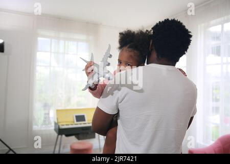 Shot of happy interracial family of mother father and their daughter ...