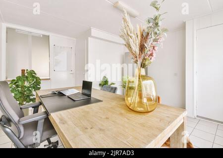 Comfortable chair placed near desk with computer monitors and ...