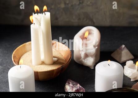 burning candles and crystals for magic ritual Stock Photo - Alamy