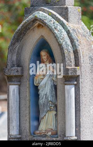 Christ figure in small shrine at grave in Inverell Cemetary, northern ...