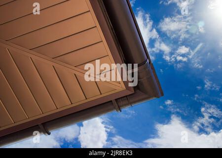Roof gutter pipeline sysem on corner of house. Building rain gutter ...
