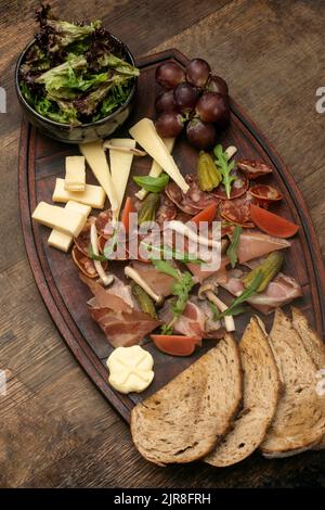 mixed european charcuterie and cheese cold cuts platter on wood table ...