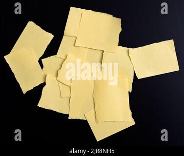 Torn yellow paper on black background Stock Photo - Alamy