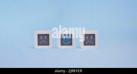 Set of computers with stylized faces of happy and sad faces on lcd ...