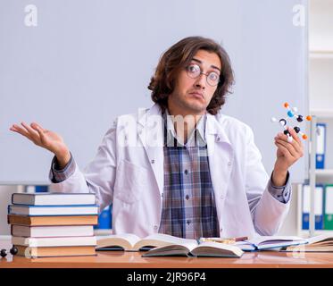 The chemistry lecturer during lecture in college Stock Photo - Alamy