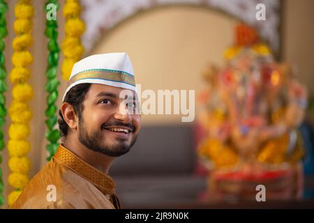 Maharashtrian man in traditional outfit praying on Ganesh Chaturthi ...