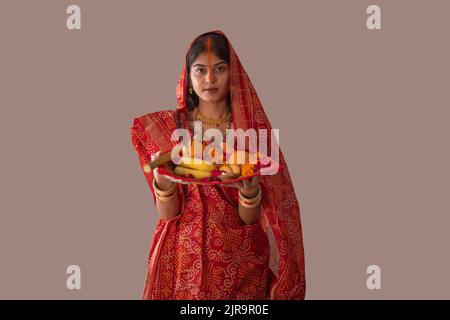 woman from Bihar offers prayers to the sun in the early morning hours ...
