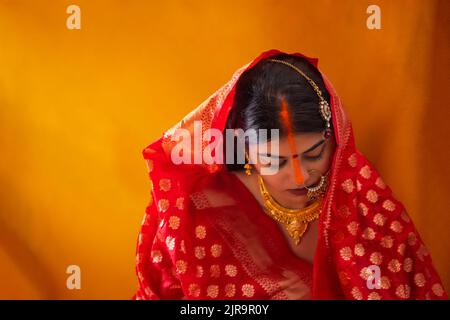 Bride from Bihar in the midst of sindoor ceremony, in a traditionally ...
