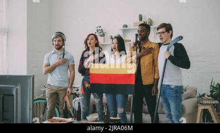 Germany fans sing their national anthem and wave flags before the World ...