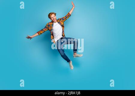 Photo of funky positive guy with ginger hairstyle dressed plaid shirt ...
