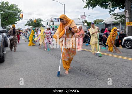 Devout Sikh women and men sweep 101st Avenue where a parade float carry ...