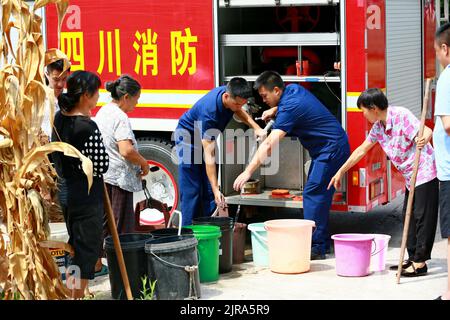 SUINING, CHINA - AUGUST 23, 2022 - Villagers carry water home in ...