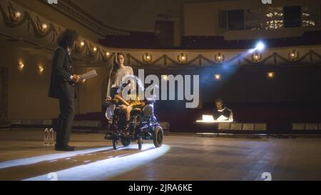 Theater actors with a disabled actress in a wheelchair with scripts ...