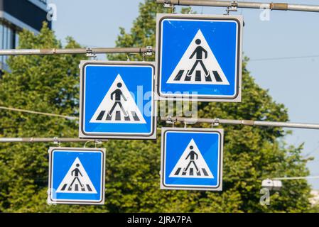 Munich, Germany. 23rd Aug, 2022. Three signs signal the crossing for ...