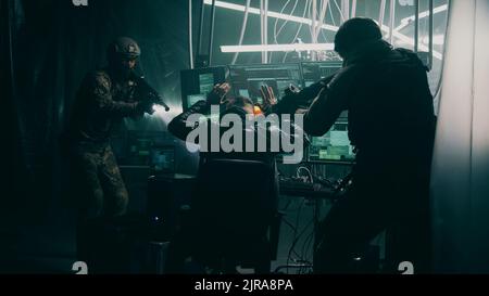 Tactical team in armor breaking into dark room and putting handcuffs on ...