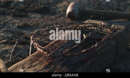 Bloody crown of thorns placed on wooden cross with signboard after ...