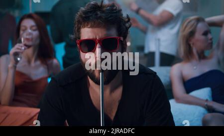 Man in sunglasses smoking a hookah Stock Photo - Alamy