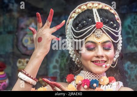 Concept Agomoni shoot with black haired Indian brunette woman face with ...