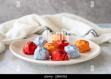 Special chocolate or gilded chocolate. Chocolates covered on gray ...