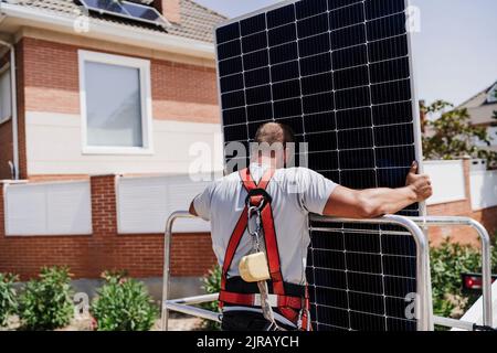 Craftsman loading solar panel in hydraulic platform on sunny day Stock ...