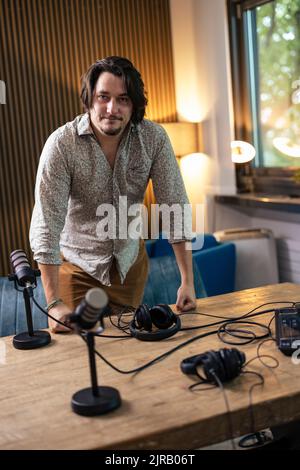 Male radio presenter with microphone recording in studio Stock Photo ...