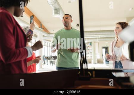 Businessman singing in the office Stock Photo - Alamy