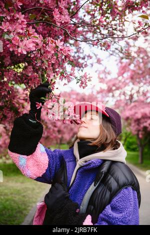 Woman smelling apple in the garden Stock Photo - Alamy