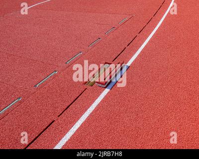 Example of a new running track with slot drain cleanout with cover ...