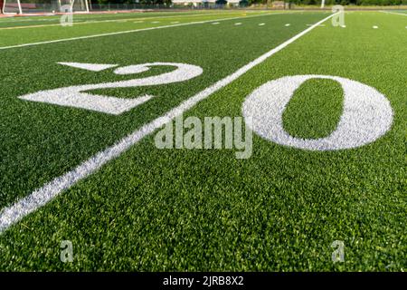 Synthetic turf football field twenty, 20, yard line in white Stock ...
