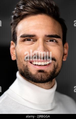 Attractive smiling young businessman wearing suit walking outdoors ...