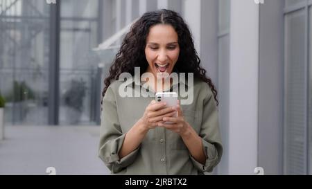 Surprised happy lucky girl winning online internet lottery smiling ...