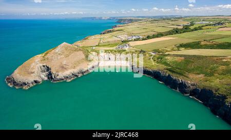 The sandy beach in the cove at Mwnt Bay west of Cardigan Wales UK, a ...