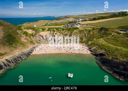 The sandy beach in the cove at Mwnt Bay west of Cardigan Wales UK, a ...