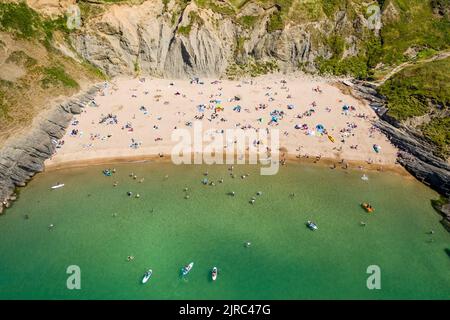 The sandy beach in the cove at Mwnt Bay west of Cardigan Wales UK, a ...